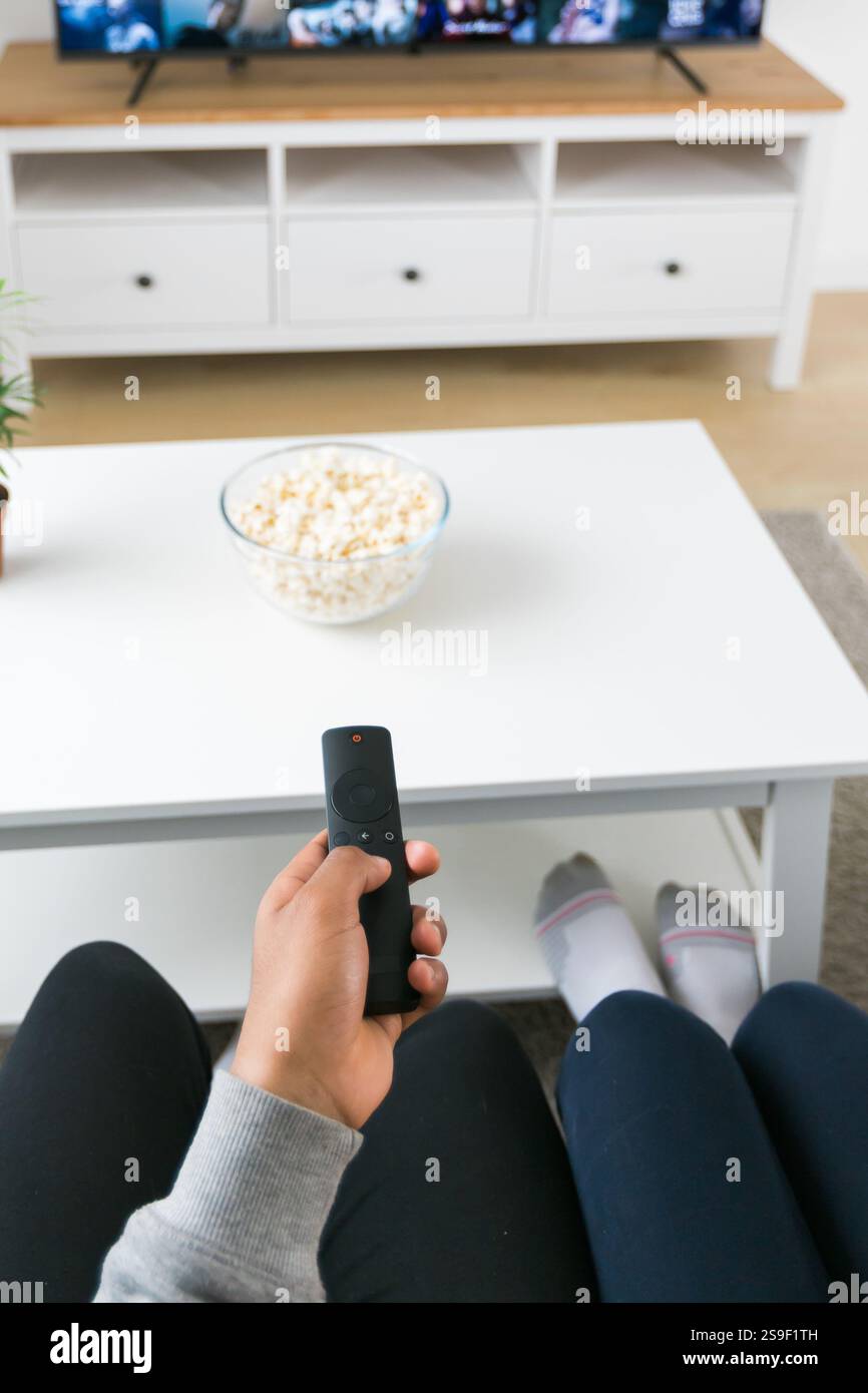 Remote control is pointed toward the television screen, control and ...