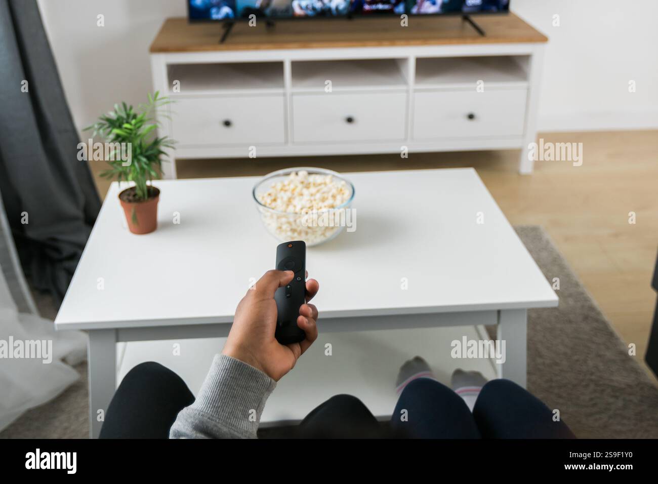 Remote control is pointed toward the television screen, control and ...