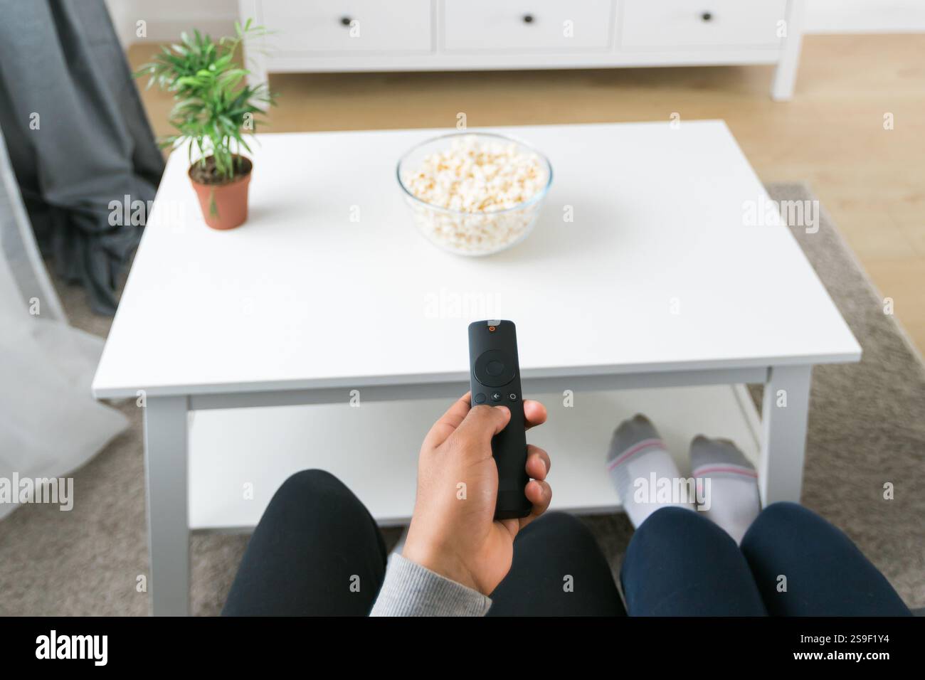 Remote control is pointed toward the television screen, control and ...