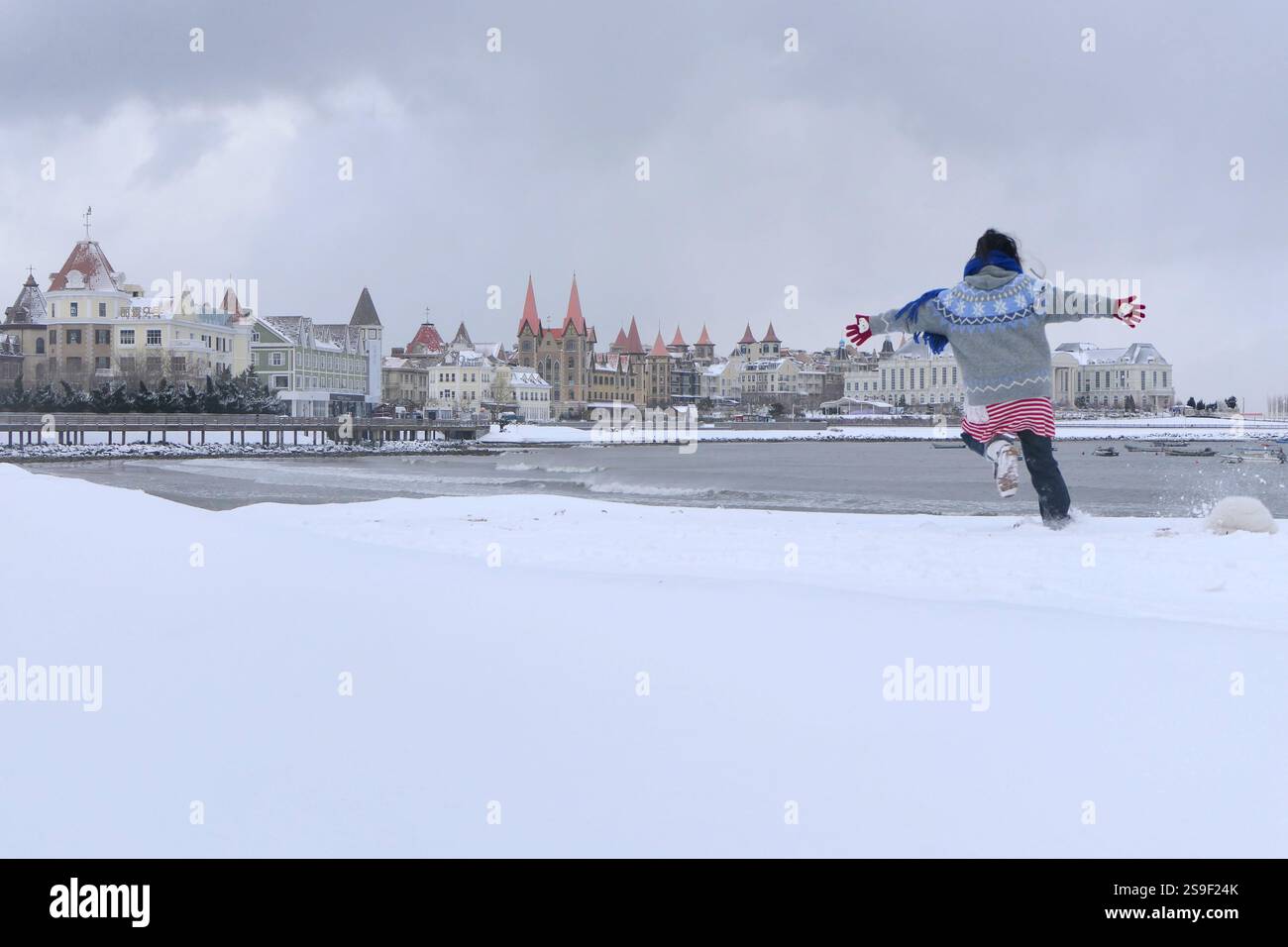 YANTAI, CHINA - JANUARY 9, 2025 - A tourist runs at the Fisherman's ...