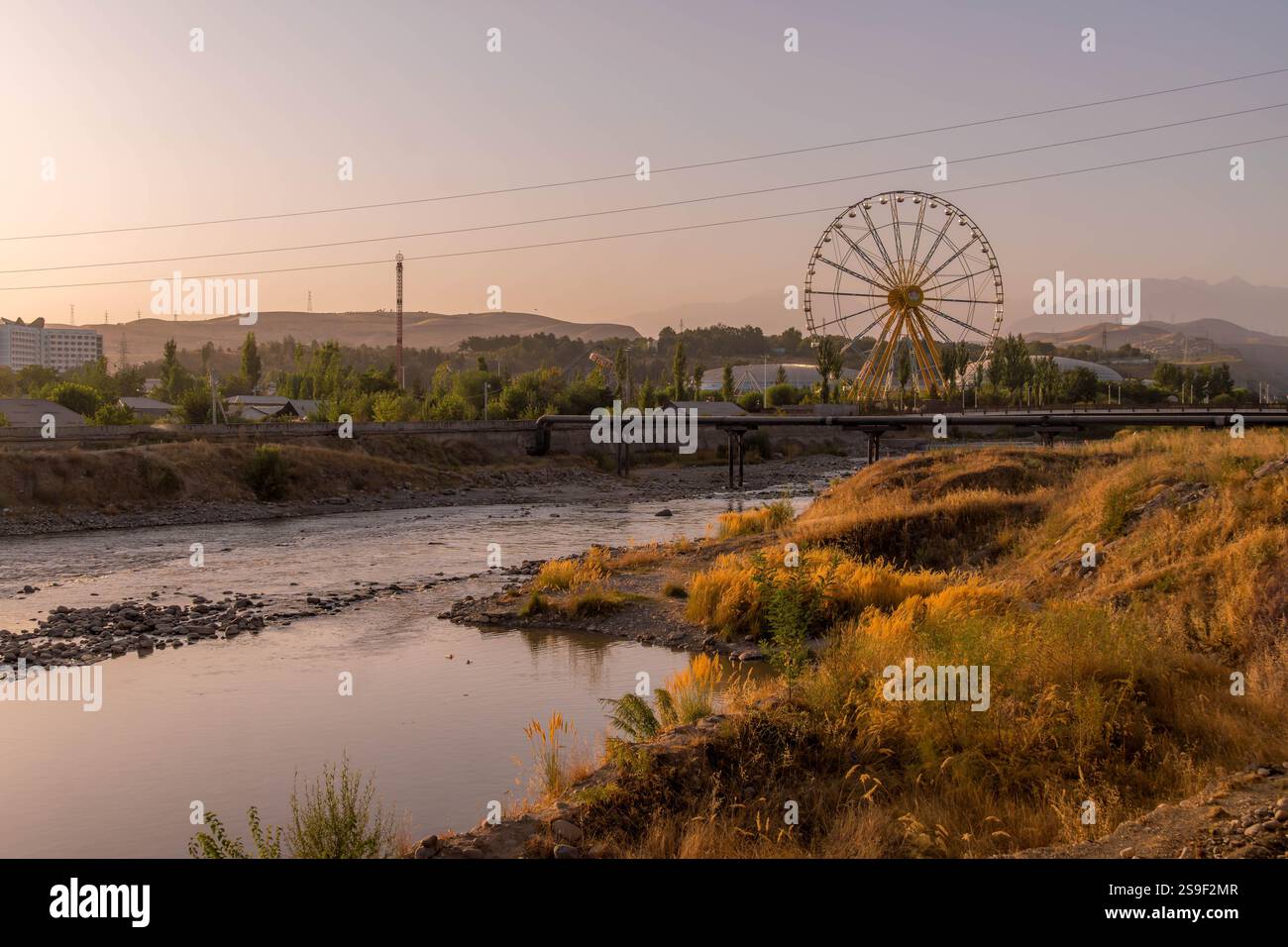The ferris wheel on the river shore in downtown Dushanbe city, the ...