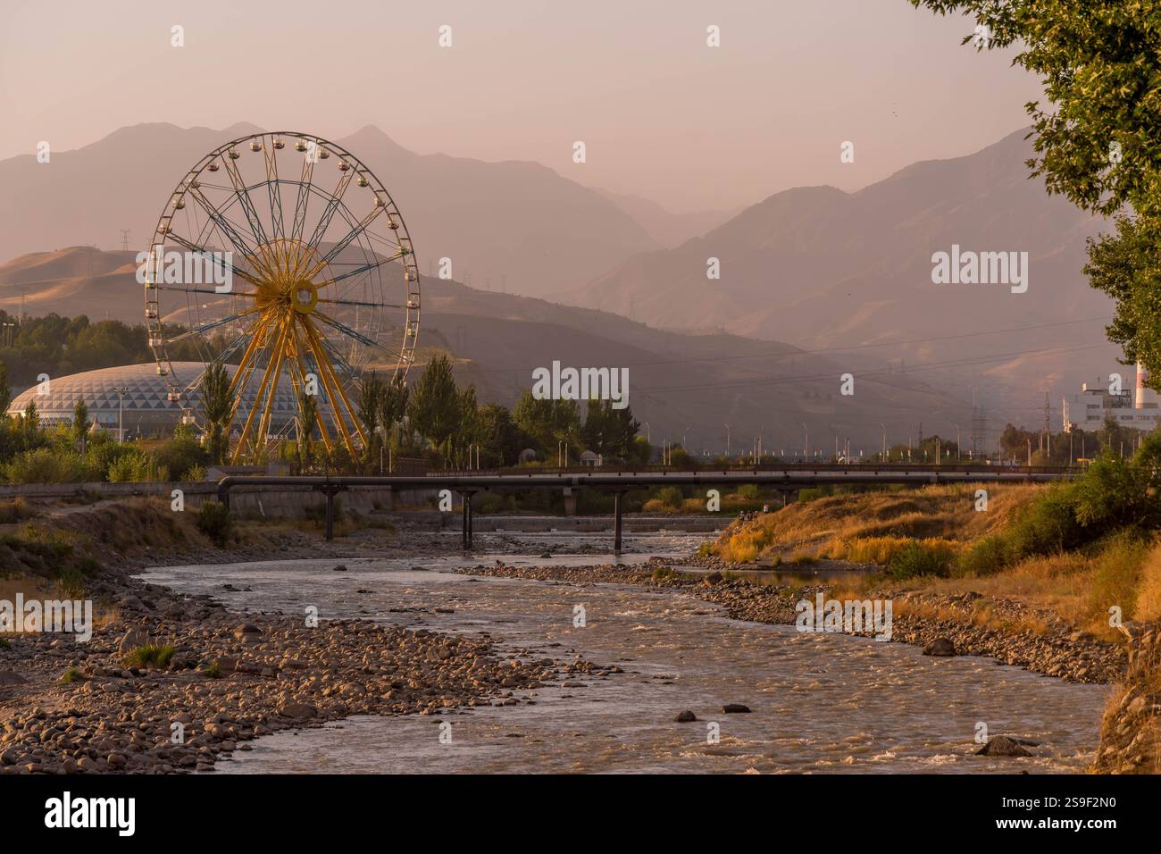 The ferris wheel on the river shore in downtown Dushanbe city, the ...