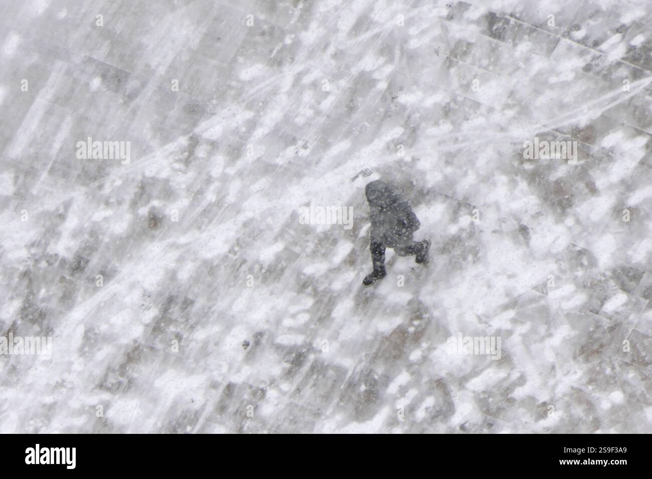 YANTAI, CHINA - JANUARY 9, 2025 - A pedestrian braves snow in Yantai ...