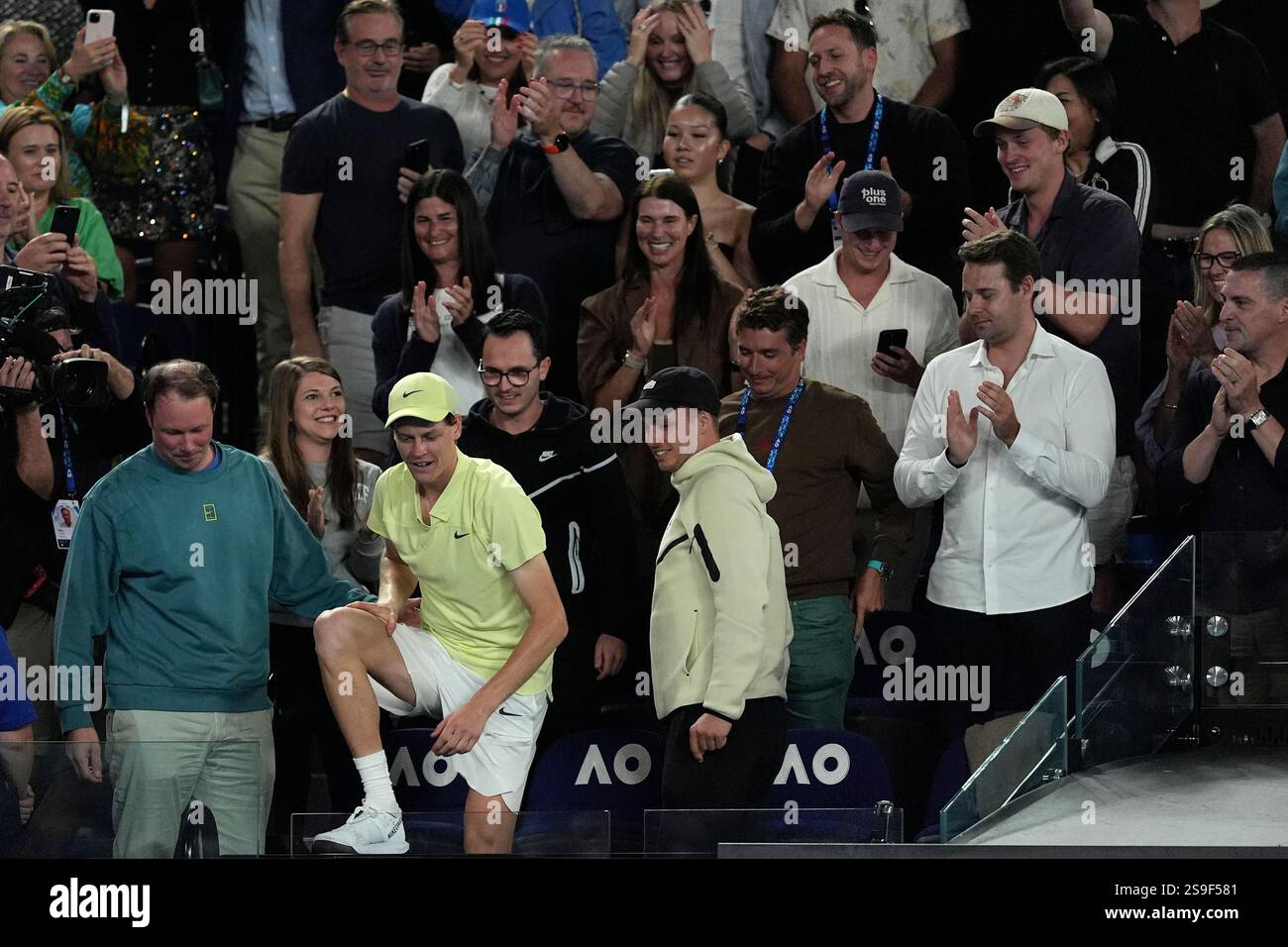 Jannik Sinner of Italy prepares to jump down from the stands as ...