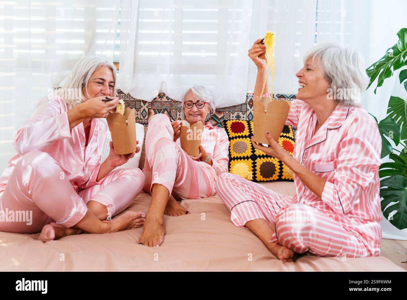Beautiful senior women having funny pajama party at home - Group of ...