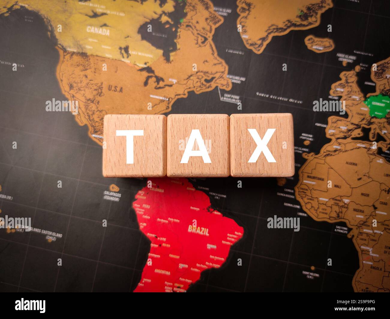 Top view wooden block with the word TAX on a world map background Stock ...