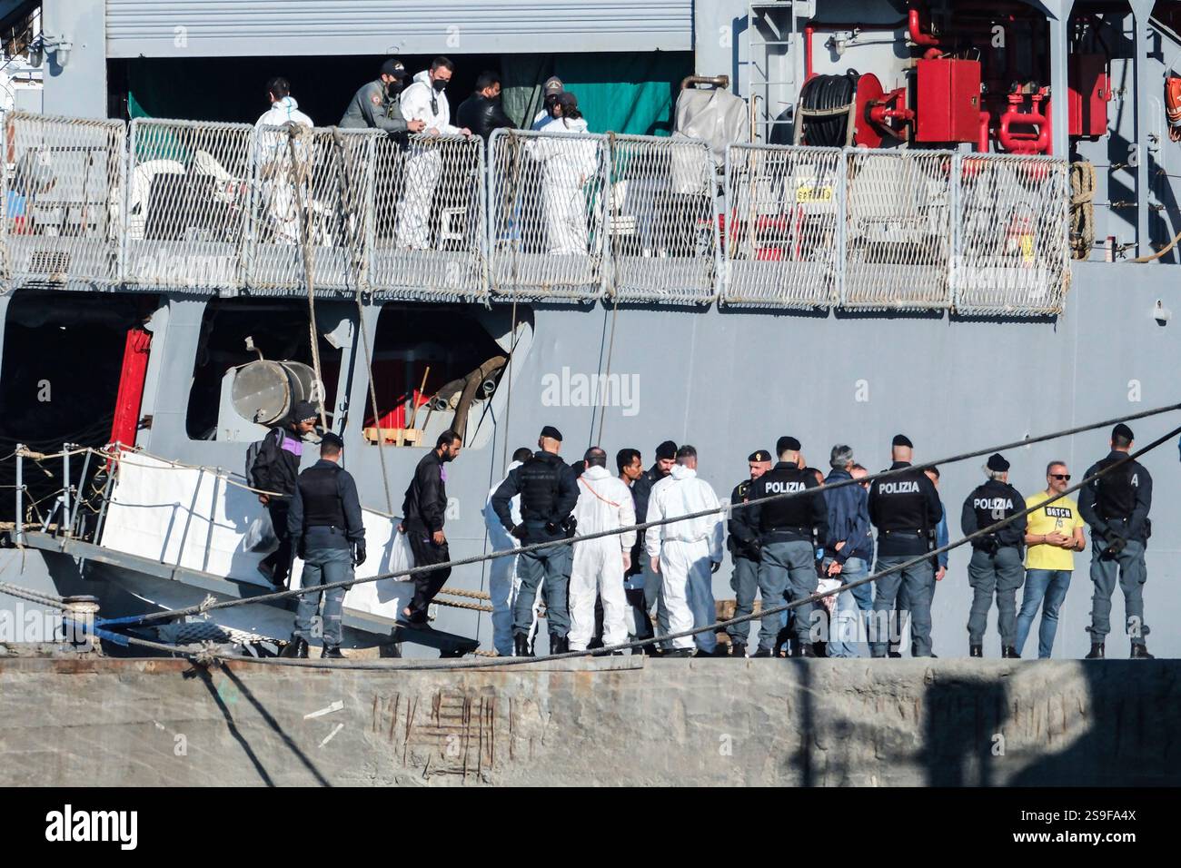 FILE - Migrants disembark from the Italian navy ship Libra at the port ...