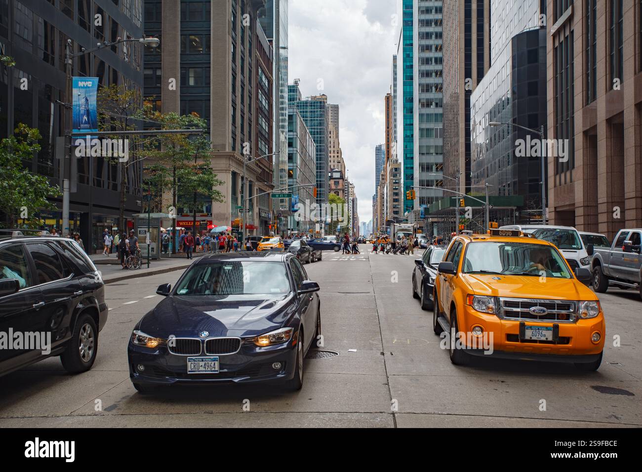A typical street with a yellow cab in Midtown Manhattan, New York City ...