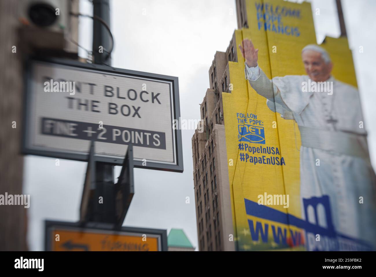 A Pope Francis advertising and a road sign Dong block the box in ...