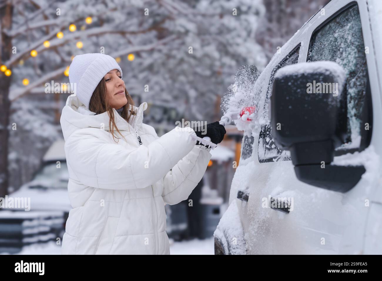 Beautiful woman cleans snow from hi-res stock photography and images ...