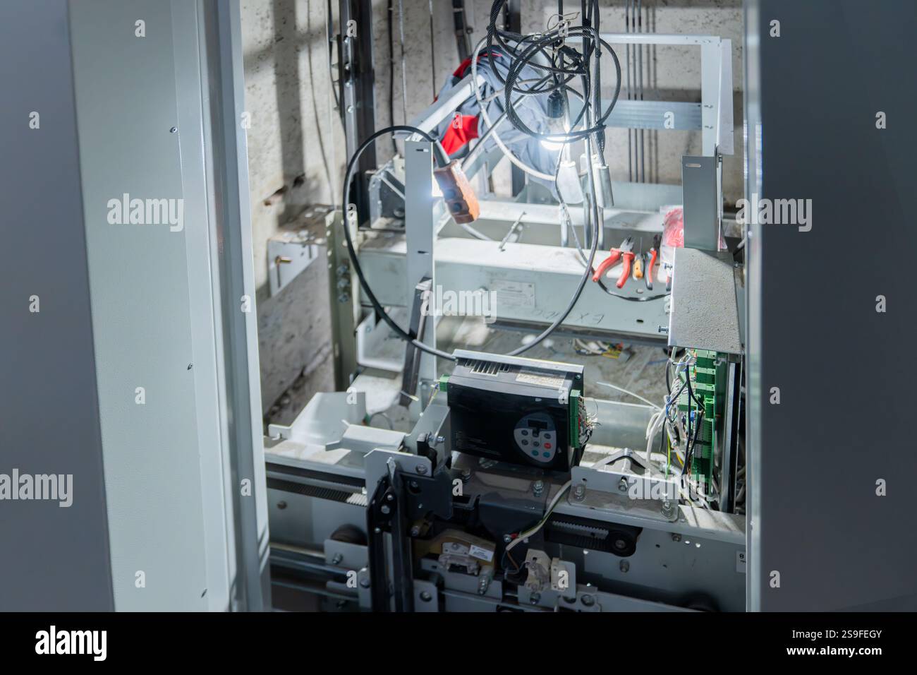 The elevator mechanisms are visible through the open doors, the ...