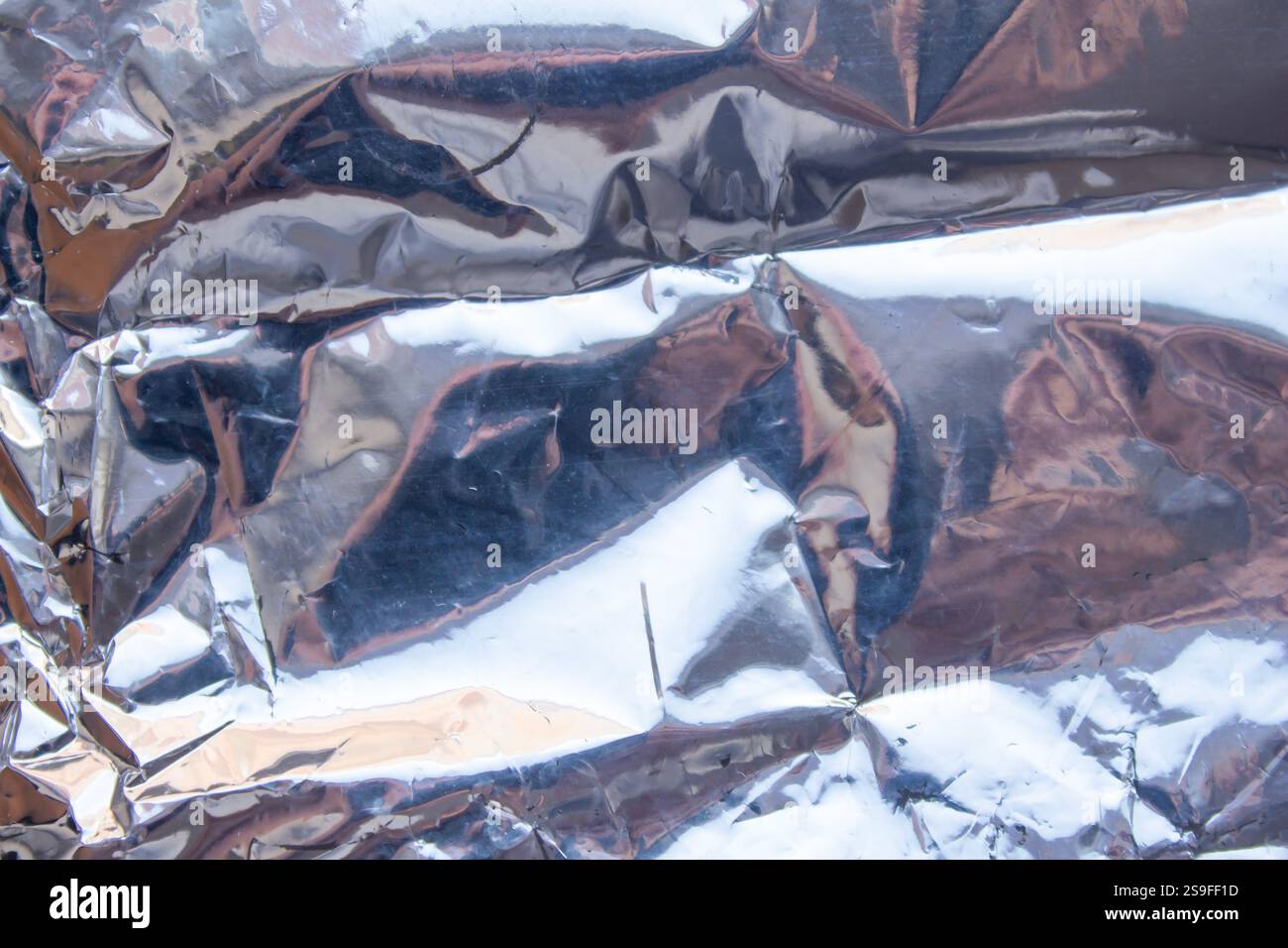 Crumpled reflective shiny gift wrapping material texture background ...