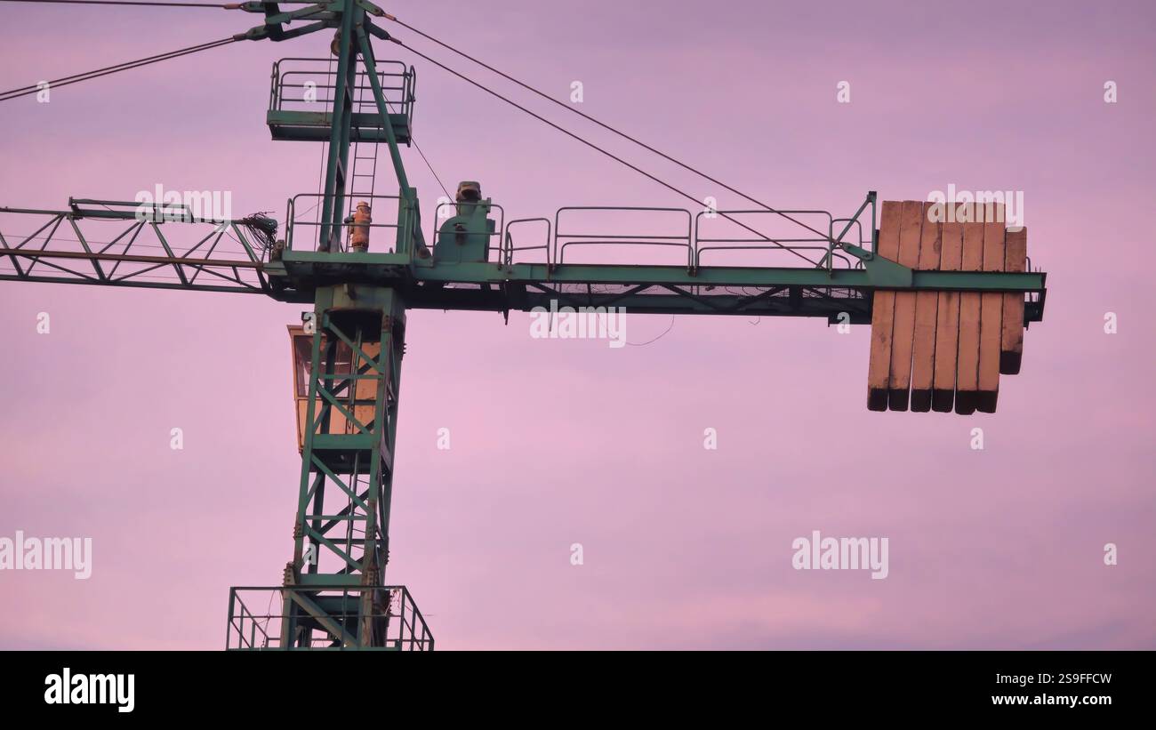 Construction crane with a long boom against the background of a light ...