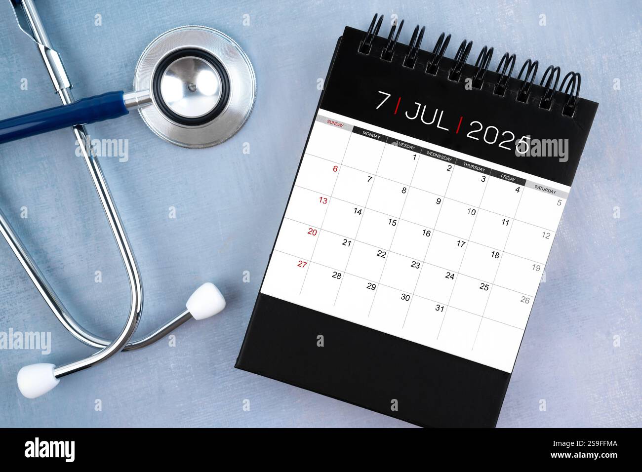 July 2025 desk calendar and stethoscope, Medical appointment schedule ...