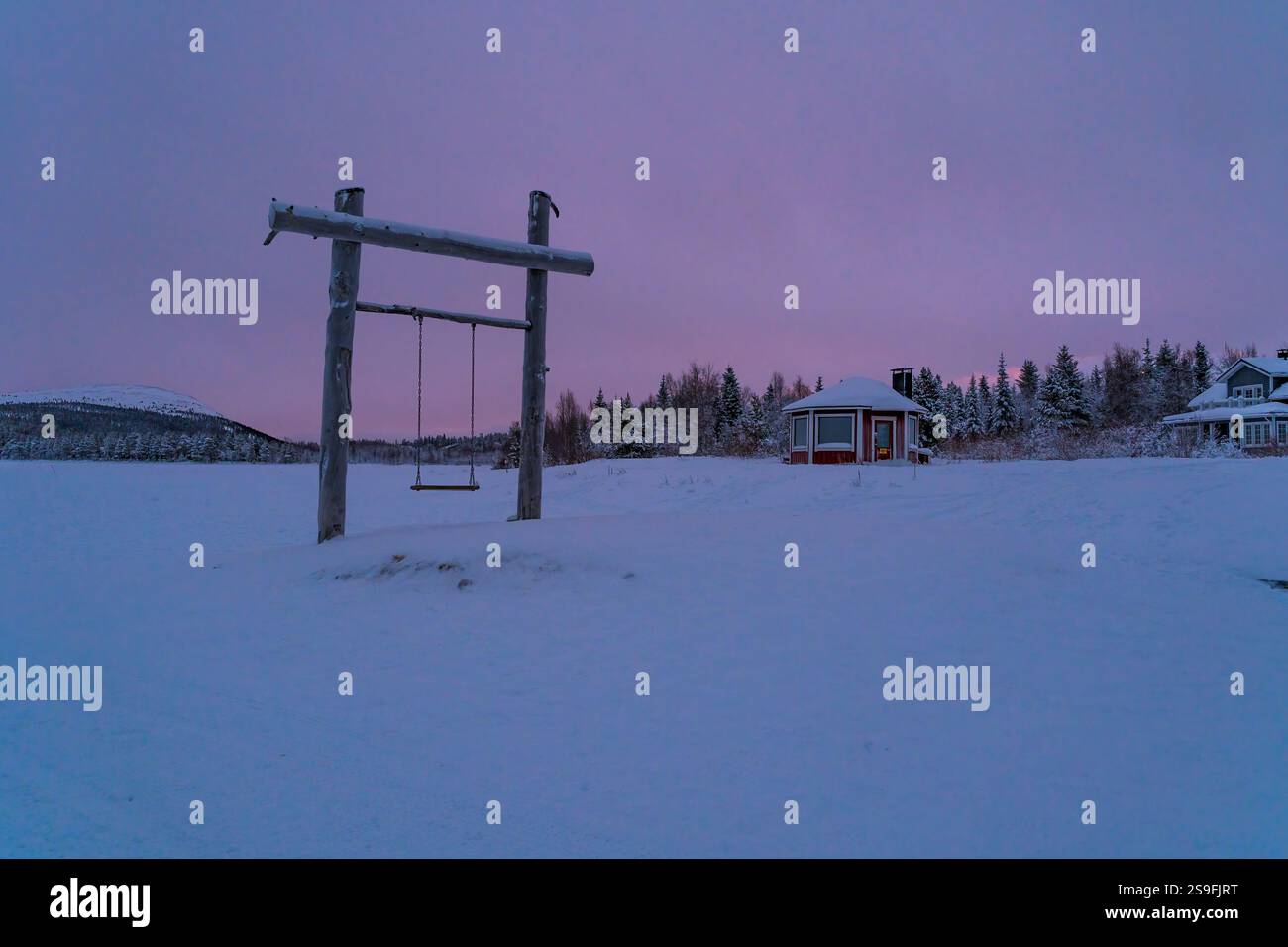 Beautiful dawn over frozen lake in Akaslompolo in Finnish Lapland ...