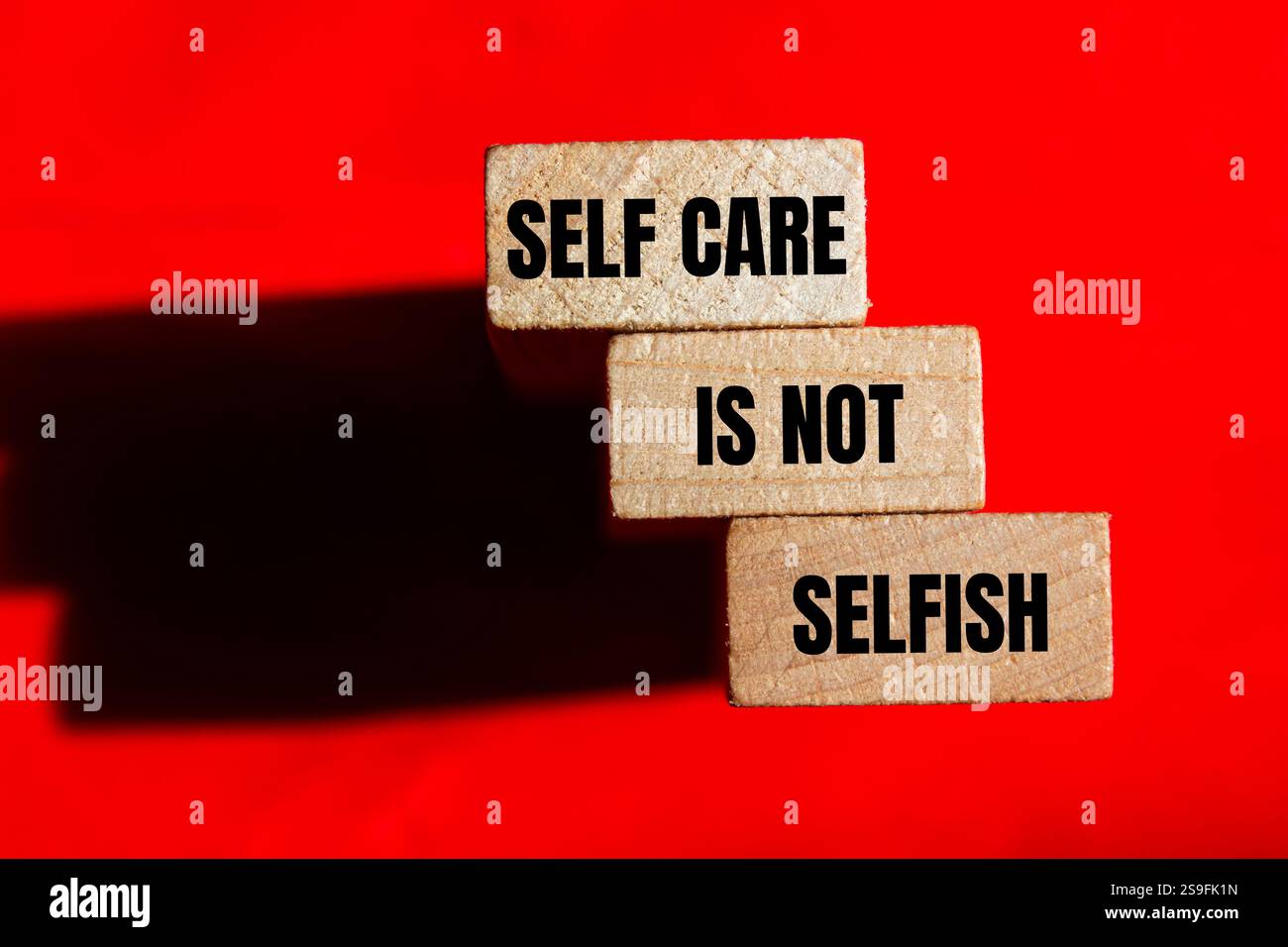 Self care is not selfish message written on wooden blocks on red ...