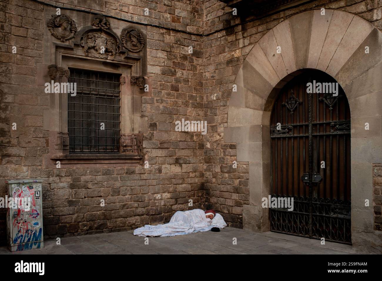 Homeless person sleeps in Barcelona's Gothic quarter streets Stock ...