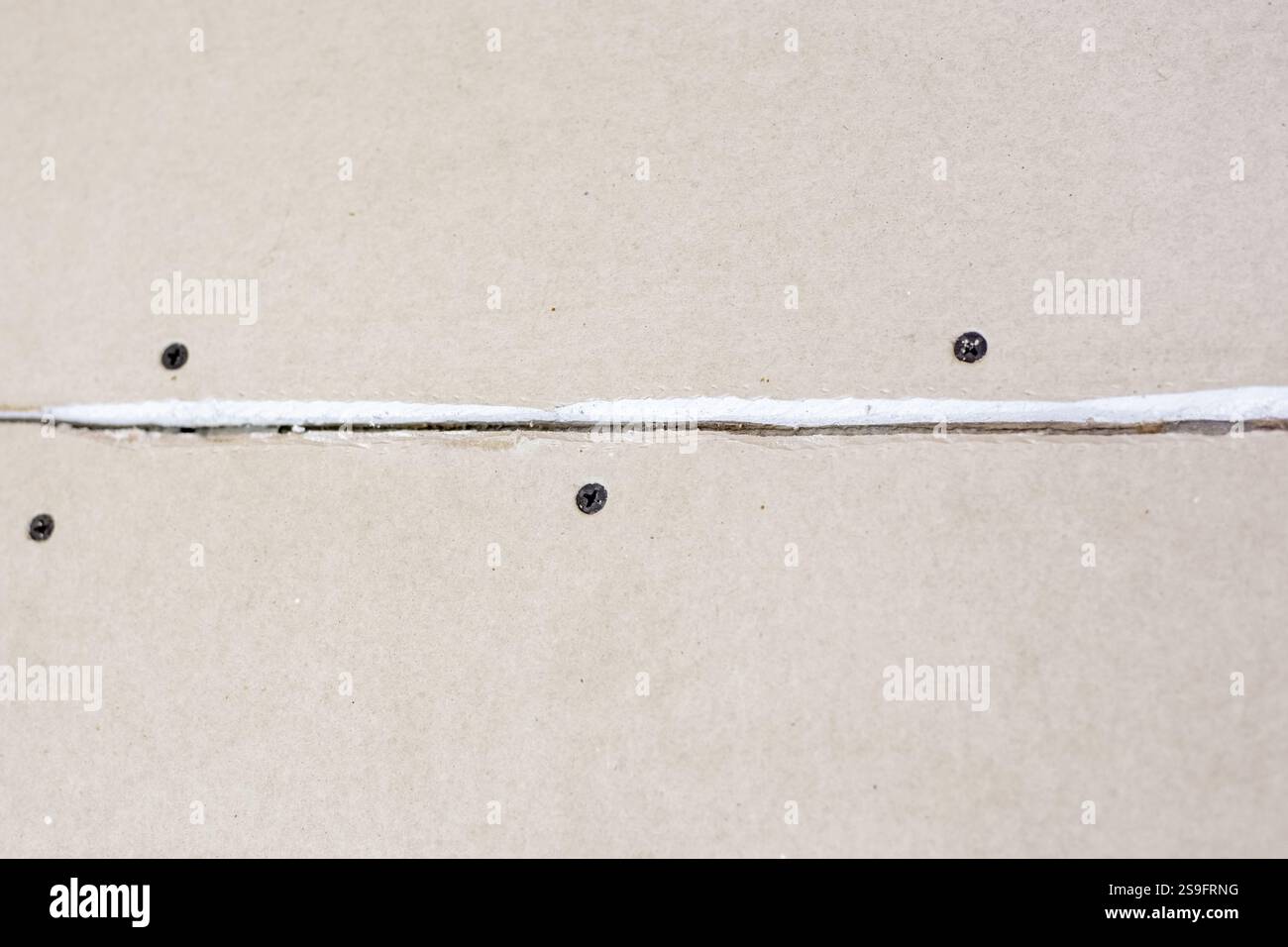 Preparing drywall for putty and plaster. The embroidered edge of the ...