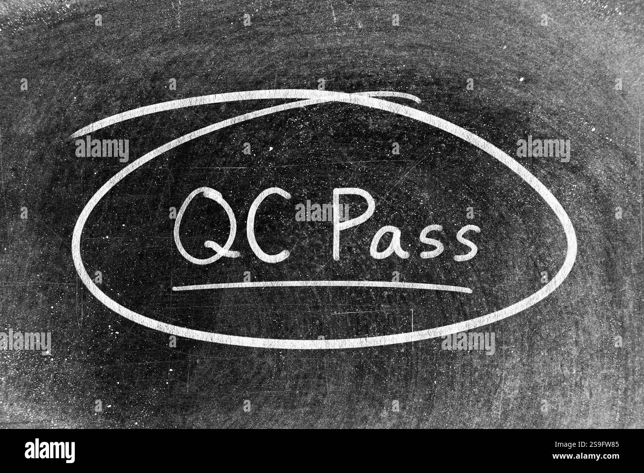 White chalk hand writing in word QC (quality control) pass and circle ...