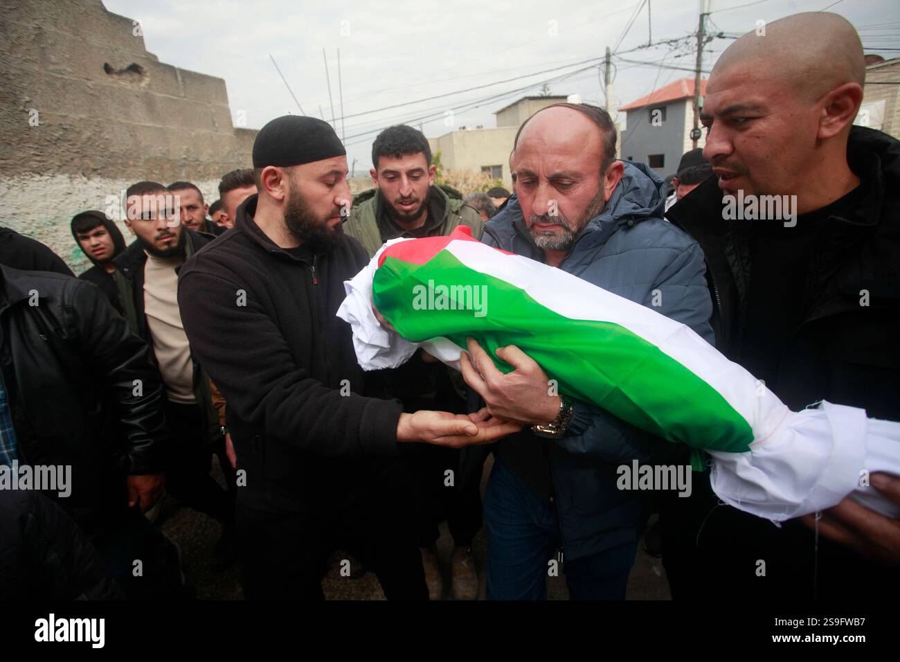 Mourners surround the flag-draped body of two-year old Laila al-Khatib ...