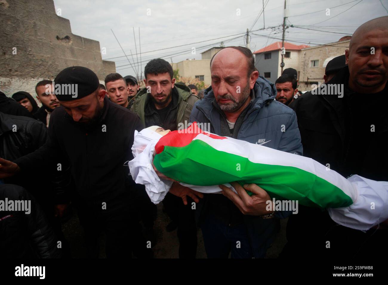 Mourners surround the flag-draped body of two-year old Laila al-Khatib ...