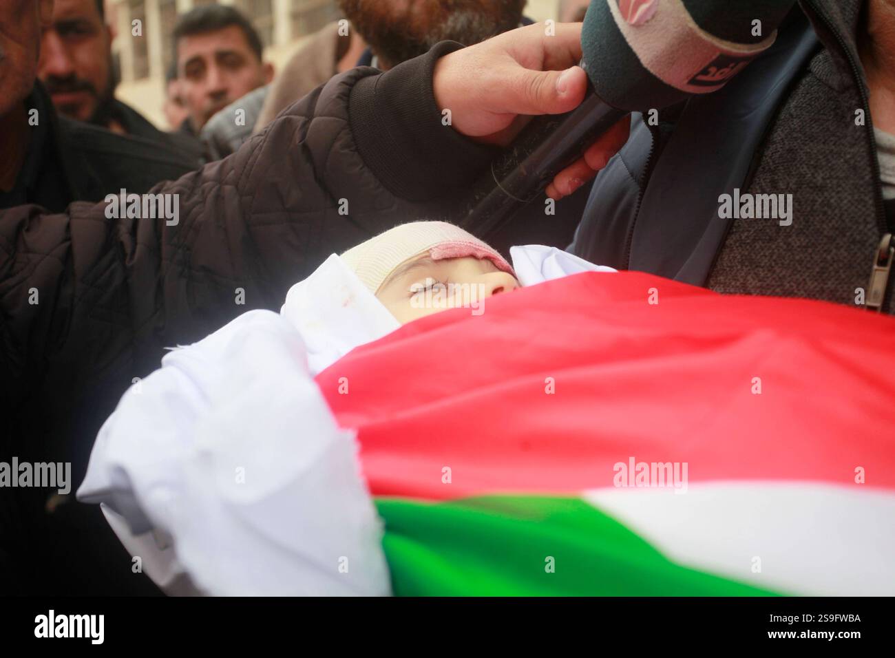 Mourners surround the flag-draped body of two-year old Laila al-Khatib ...