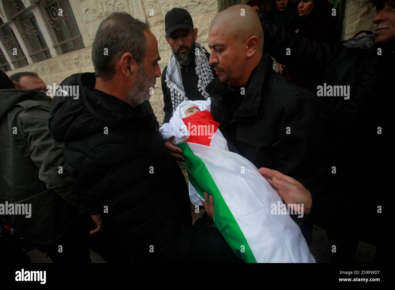Mourners surround the flag-draped body of two-year old Laila al-Khatib ...