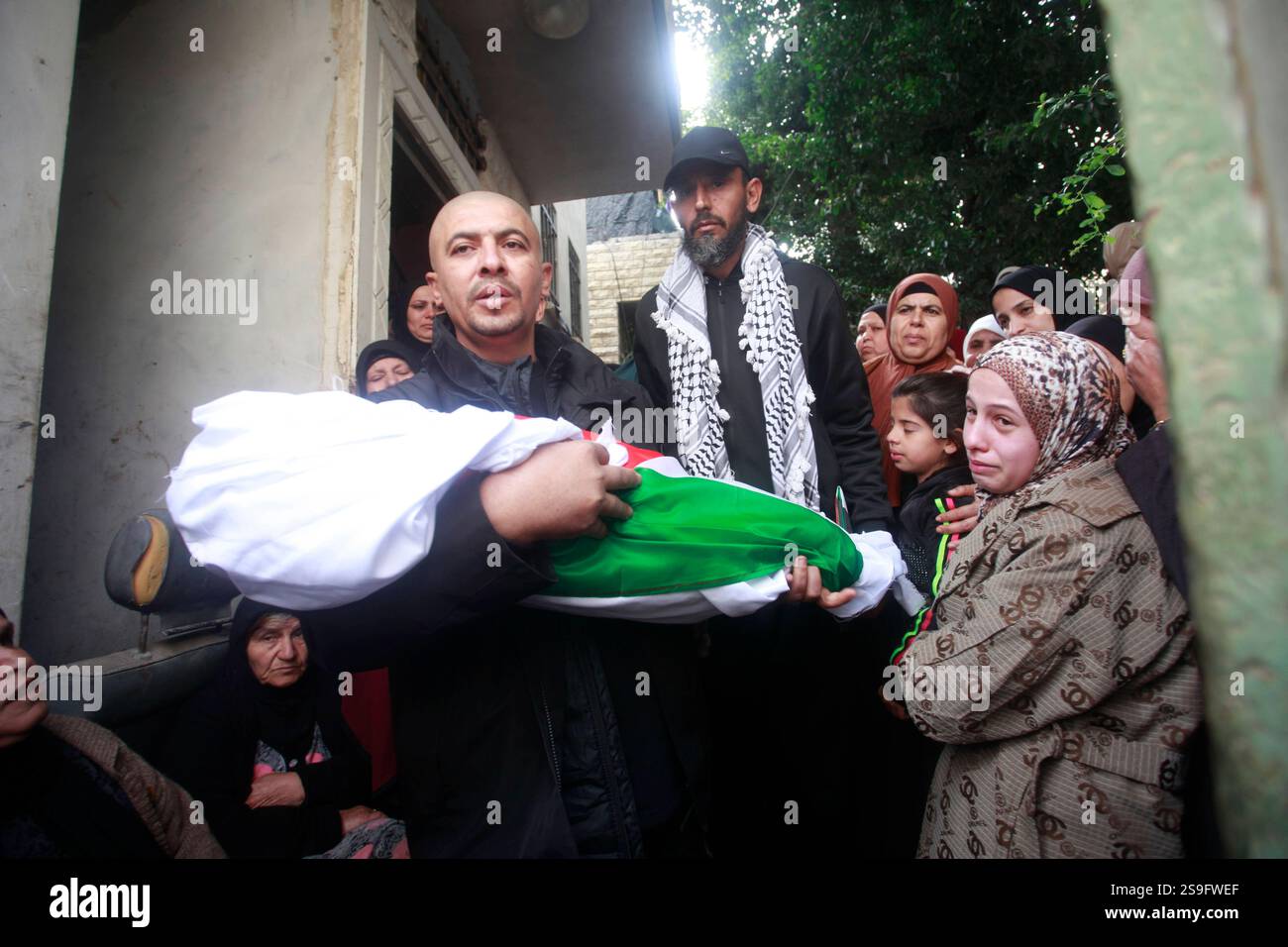 Mourners surround the flag-draped body of two-year old Laila al-Khatib ...