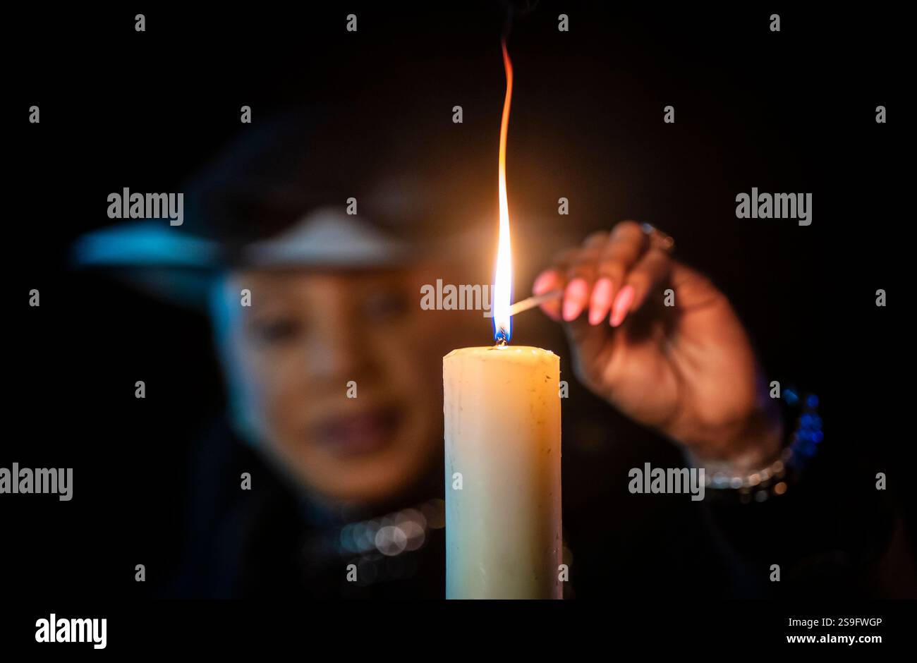 Lord Mayor Councillor Abigail Marshall Katung, lights a candle ahead ...