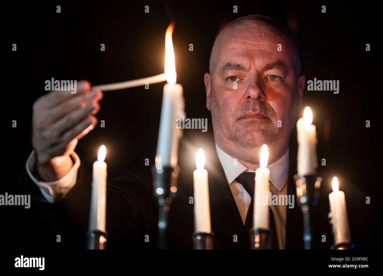 Member of the Jewish community Geoff Turnbull lights a candle ahead the ...
