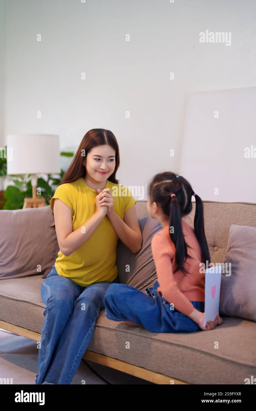 A Young Daughter Surprises Her Mother With A Handmade Card Creating A 8590