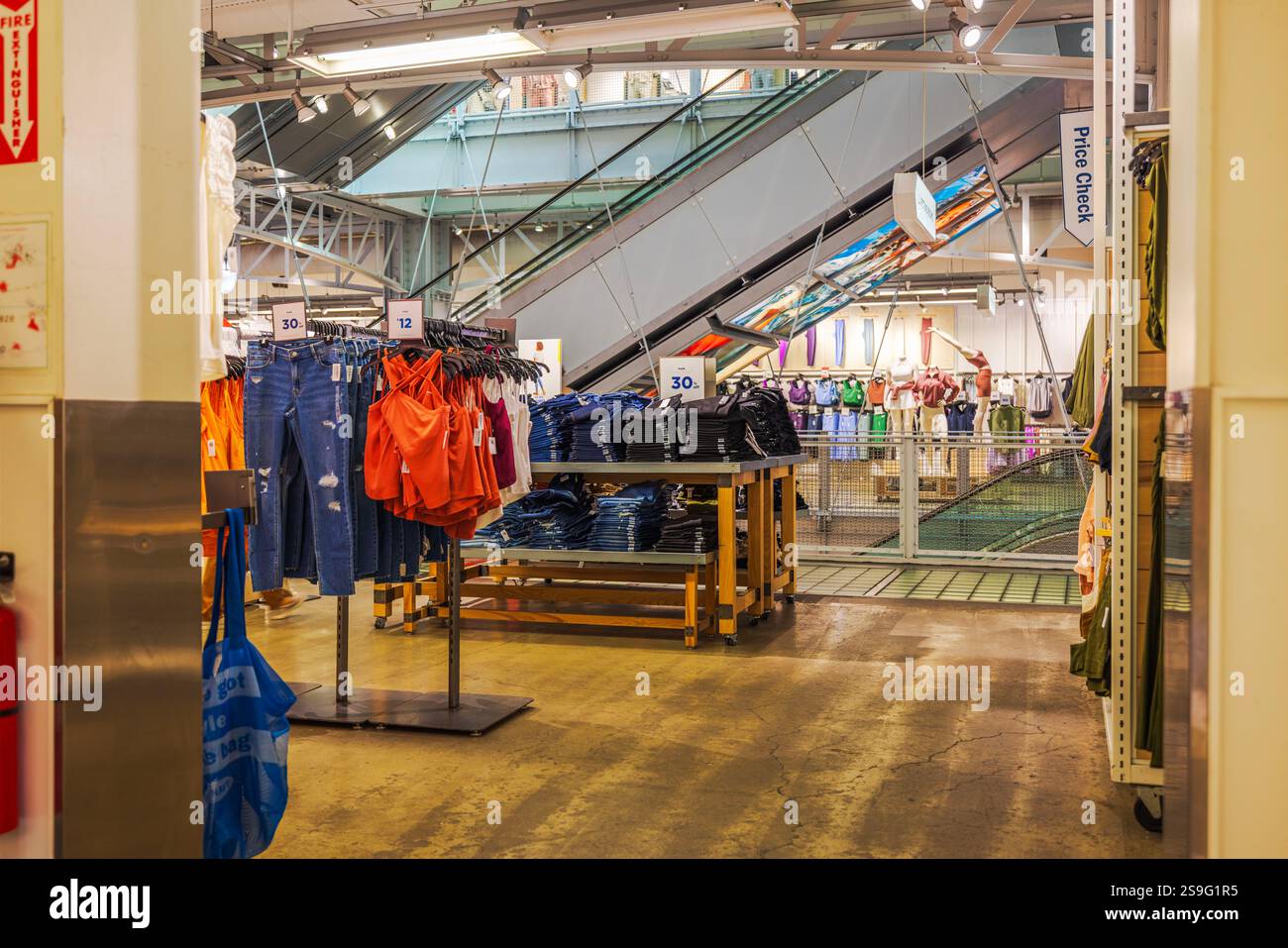 Interior of Macy's clothing store with apparel racks, jeans, and ...