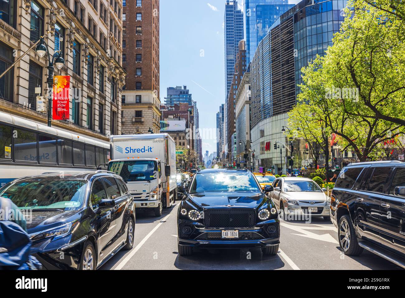 Heavy traffic in Midtown Manhattan with luxury cars, trucks and buses ...