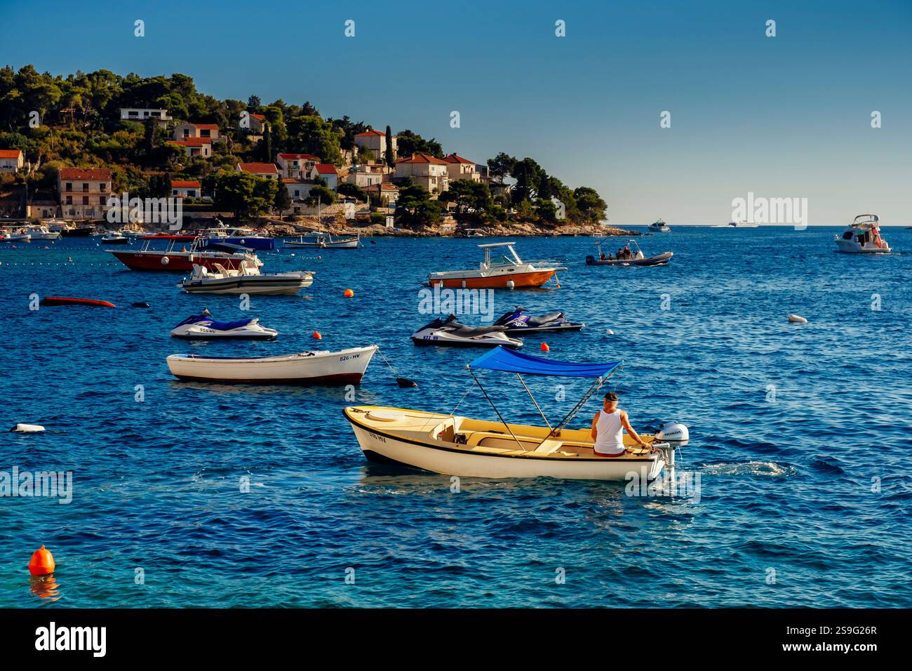 Fisherman in small boat at Krishna Luka beach, Hvar, Island of Hvar ...