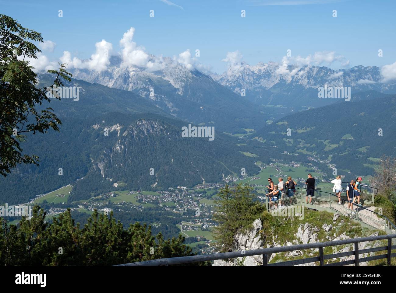 Tourists enjoying a scenic view of the Alps from the Kehlsteinhaus (commonly known as the 'Eagle ...