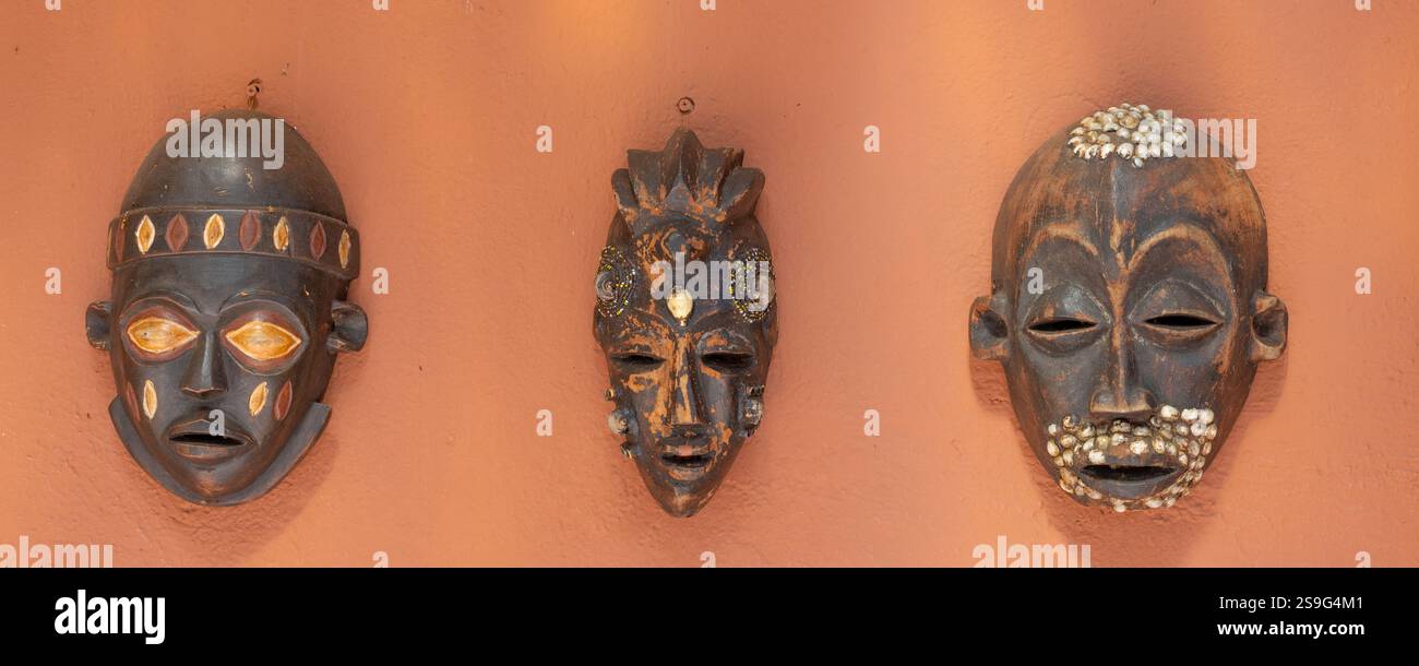 Beautiful African mask hanging on colorful wall in the sun, Symbol of ...