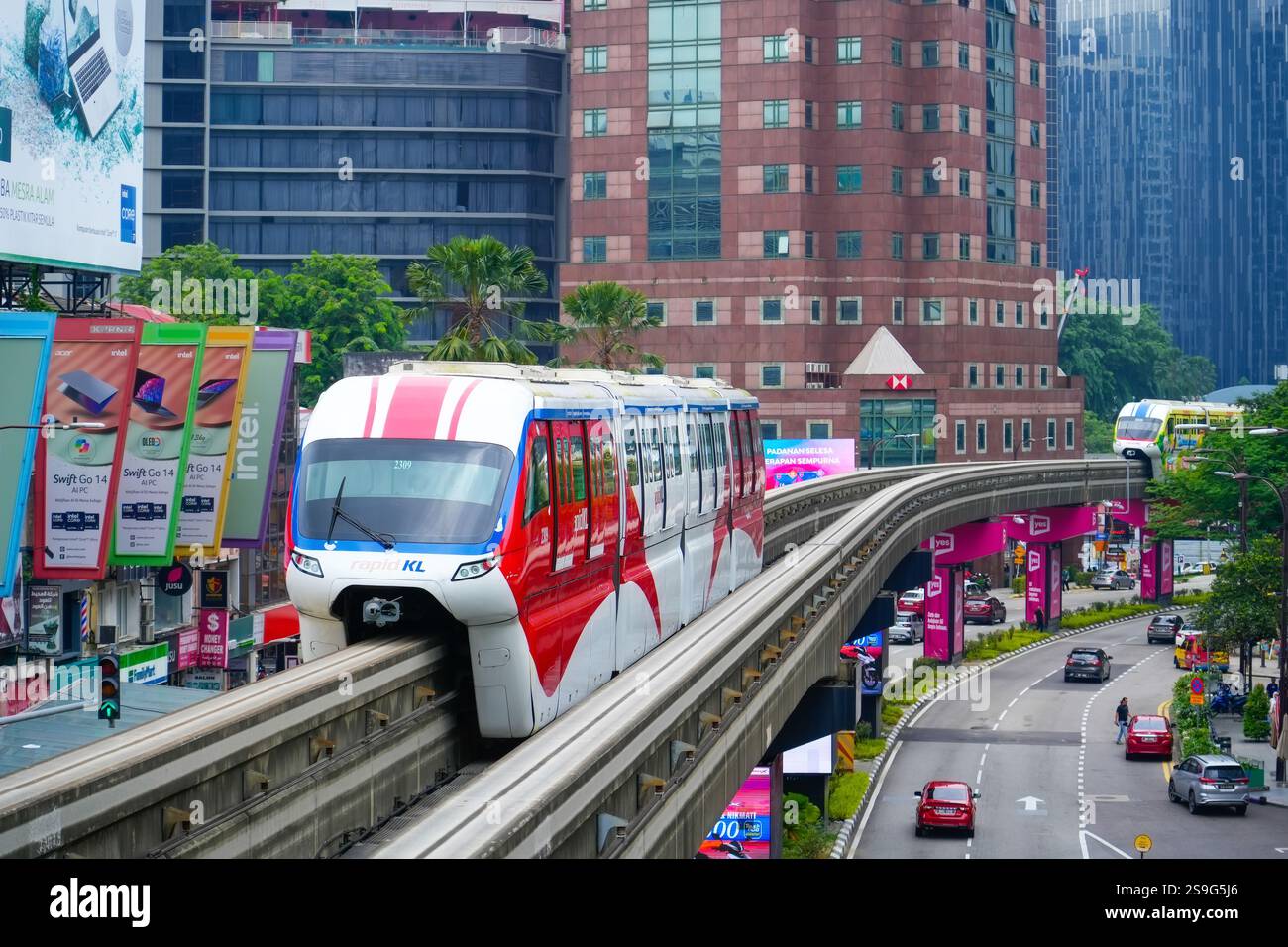 Rapid KL monorail train above the highway in the city. Modern and eco ...