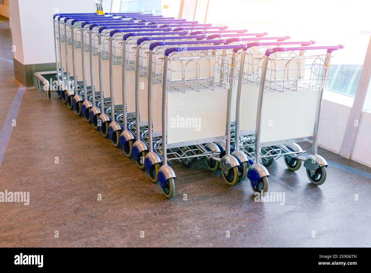 Luggage trolleys at the airport lined up in a row Stock Photo - Alamy