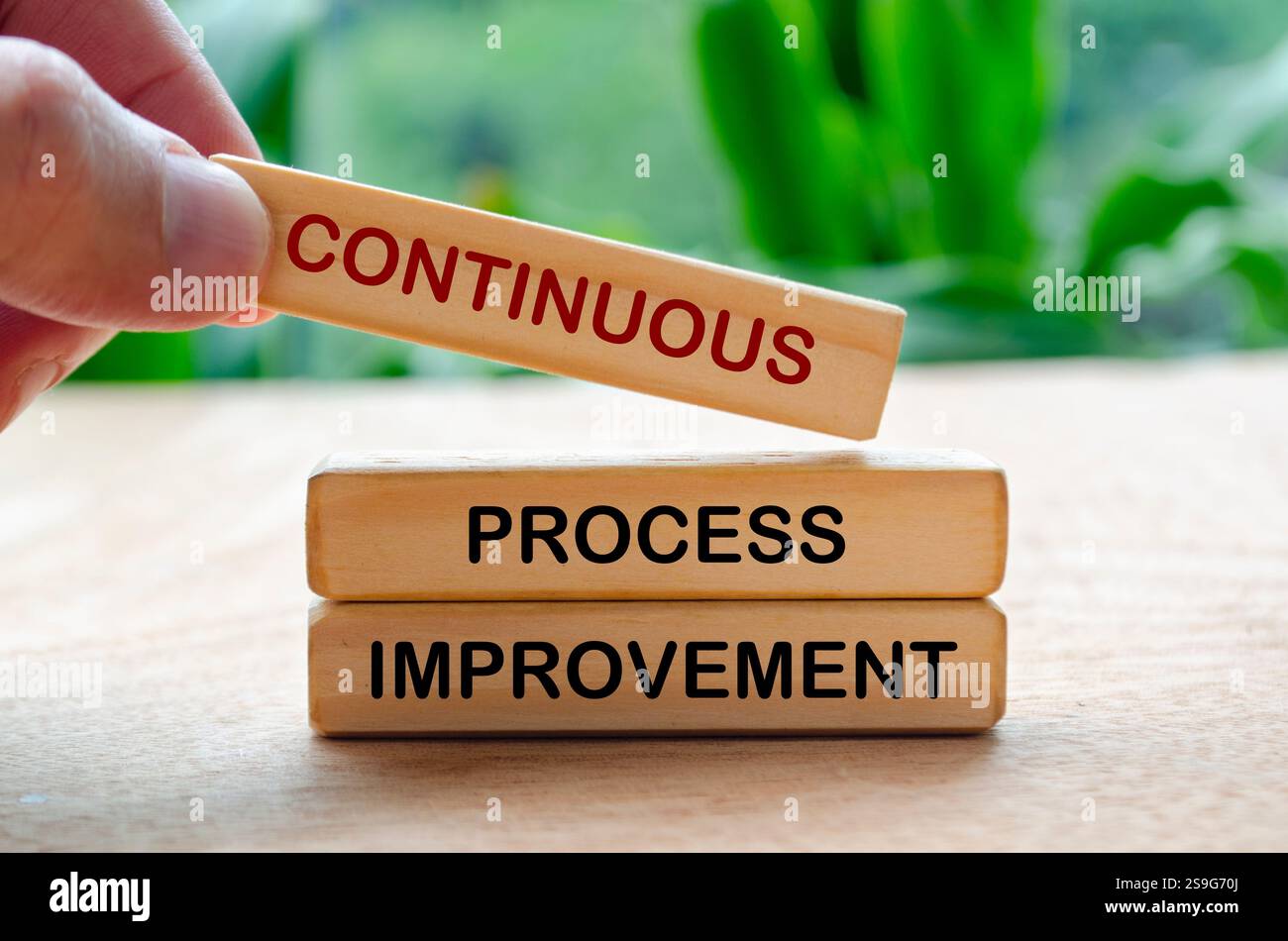 Continuous process improvement text on wooden blocks. Business strategy ...