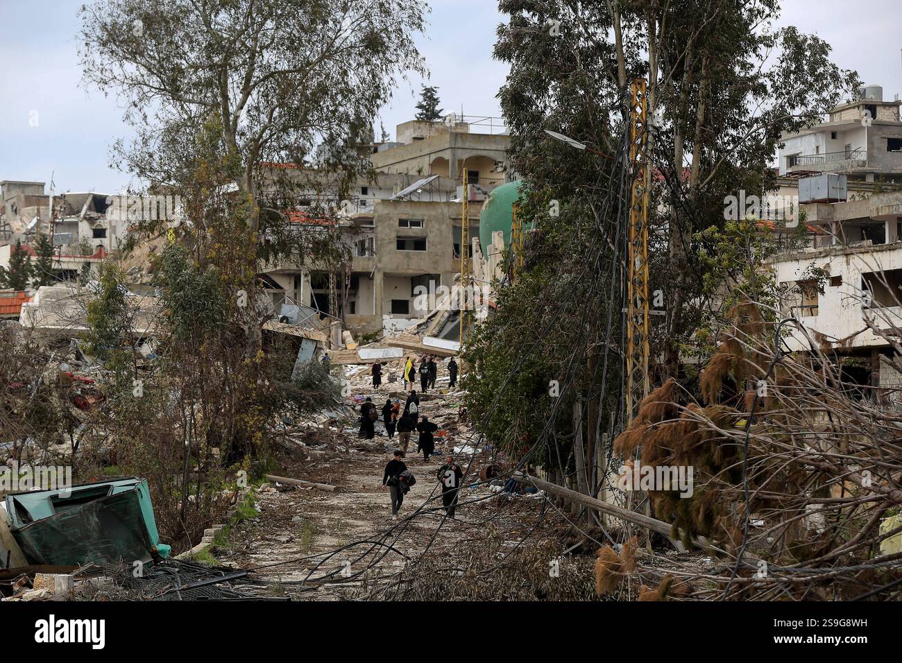 26 January 2025, Lebanon, Ayta ash-Shaab: Lebanese people walk among ...