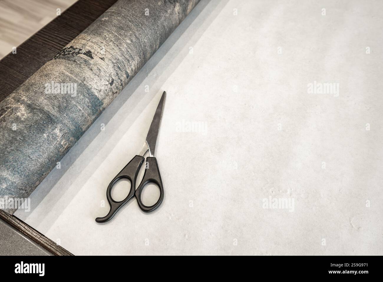 Cutting wallpaper before sticking it to the wall, scissors, measuring ...