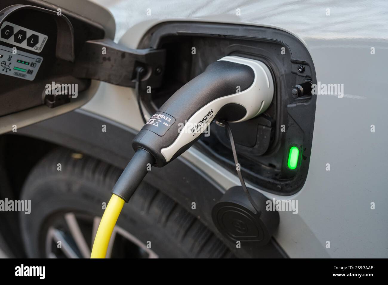 E-car being charged. Plug during the charging process on an electric ...