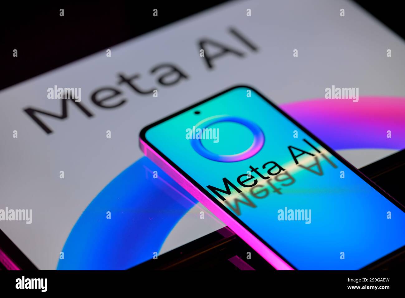 Meta AI logo is displayed on a mobile phone with Meta AI seen on tablet ...
