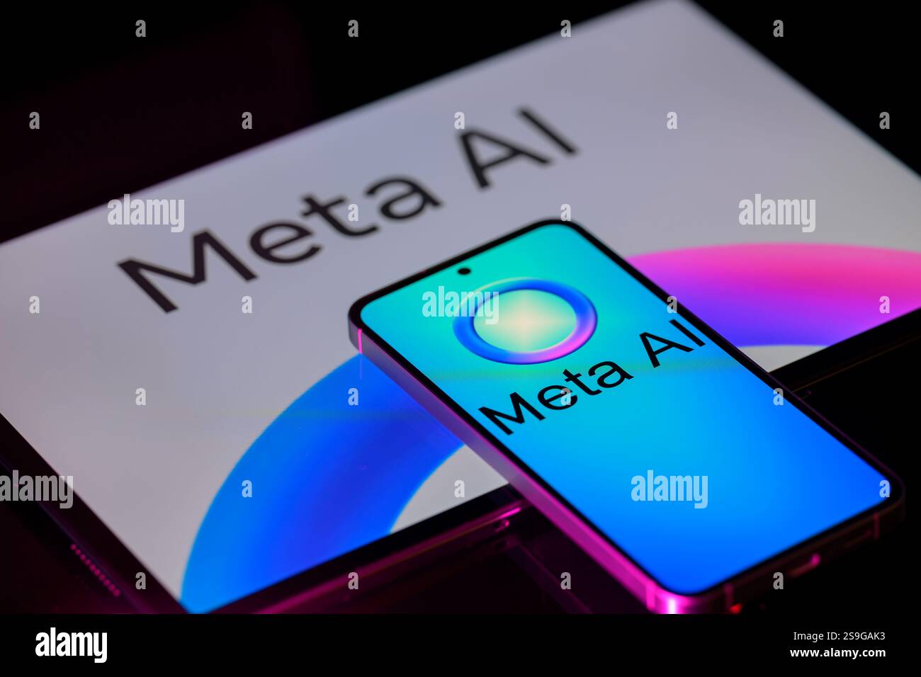 Meta AI logo is displayed on a mobile phone with Meta AI seen on tablet ...