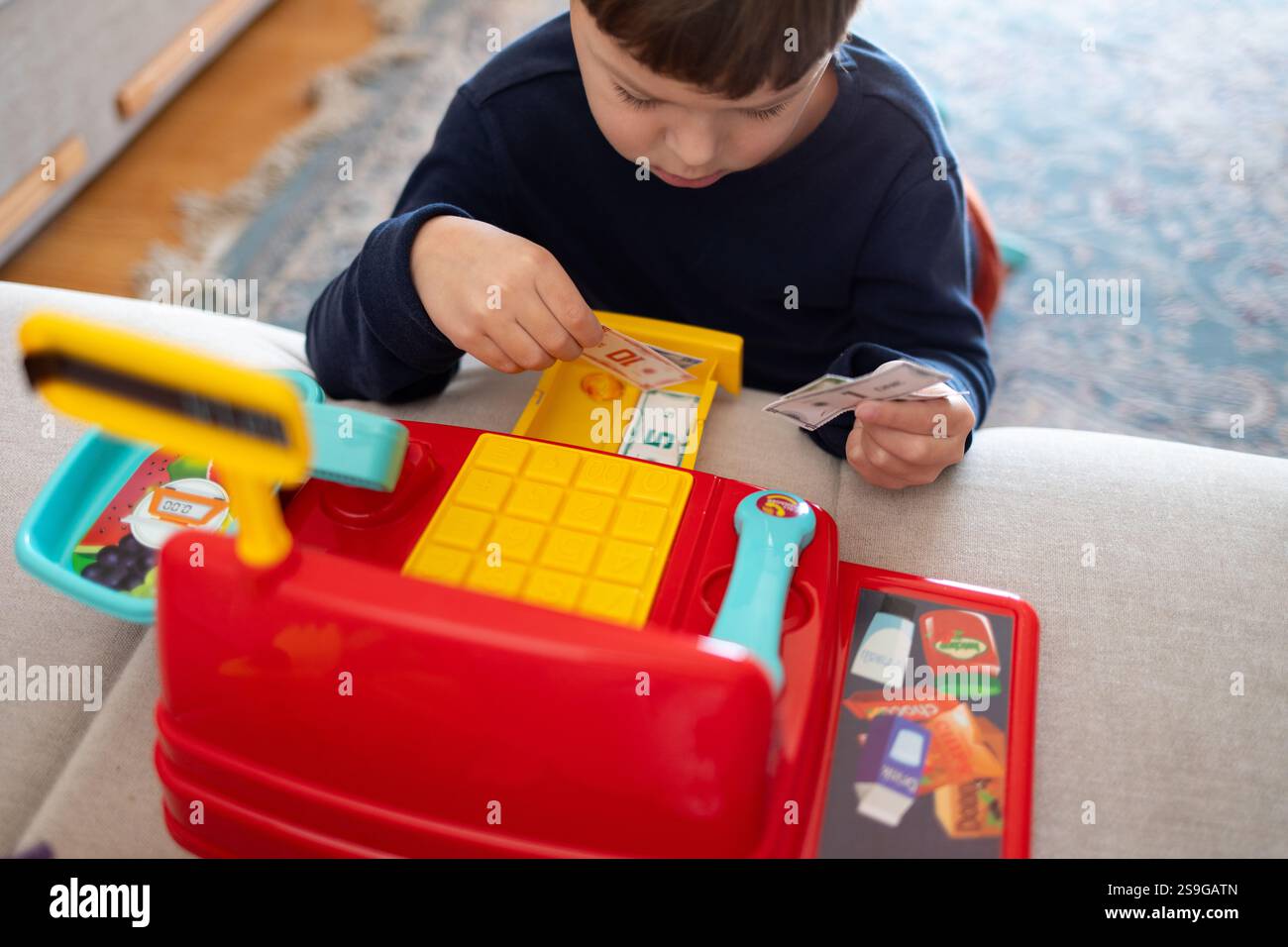 A child plays with a toy cash register and toy money Stock Photo - Alamy