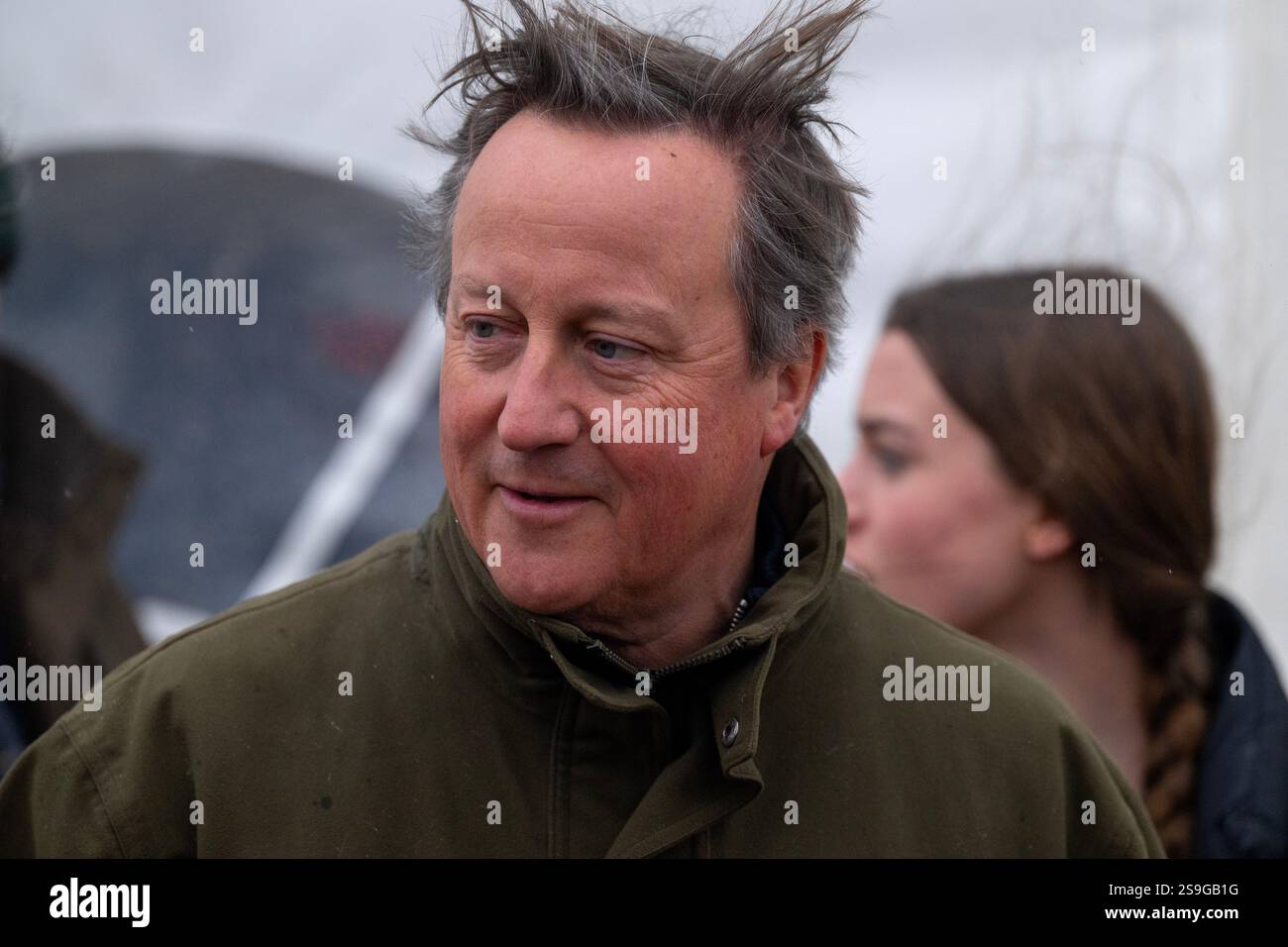 Former Prime Minister David Cameron braves the rain, wind and mud at ...