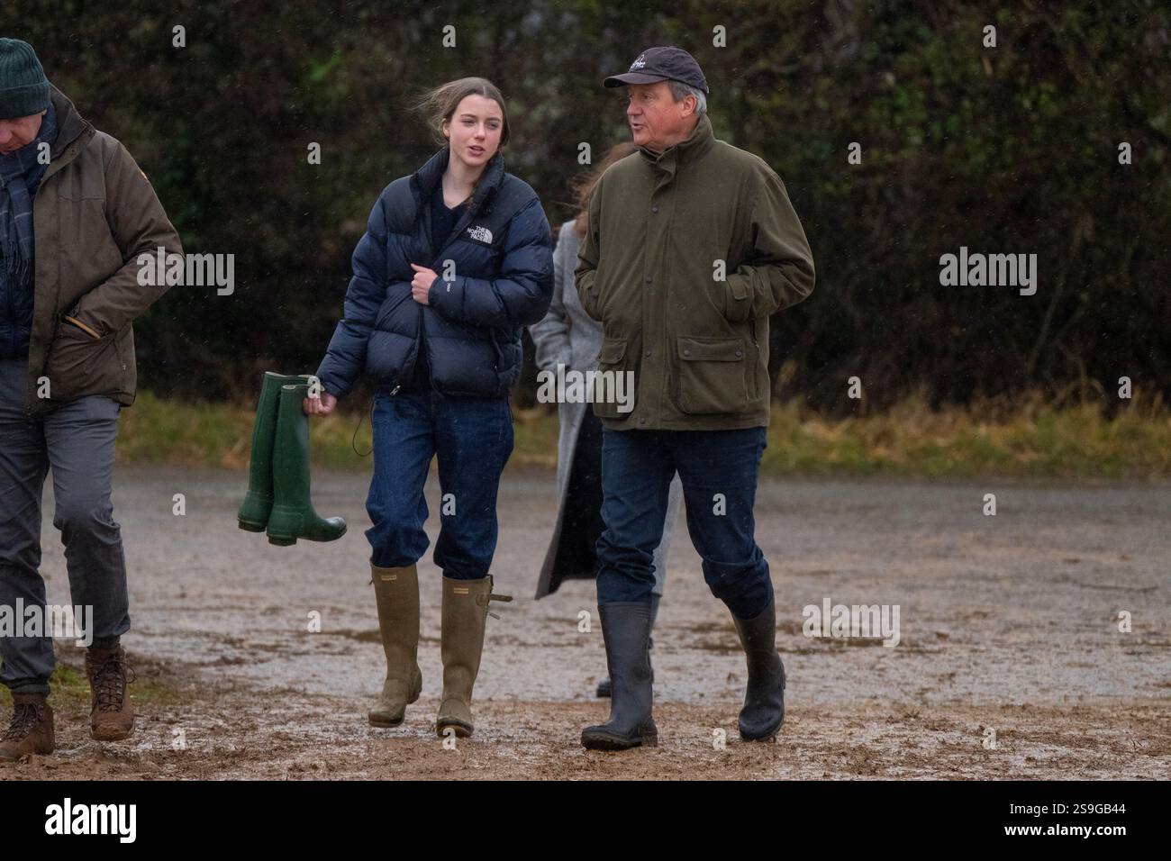 Former Prime Minister David Cameron braves the rain, wind and mud at ...