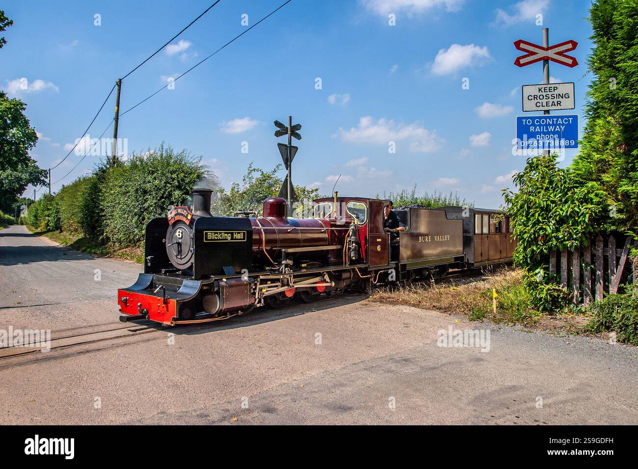 Narrow gauge steam locomotive on level crossing without barriers (prior ...