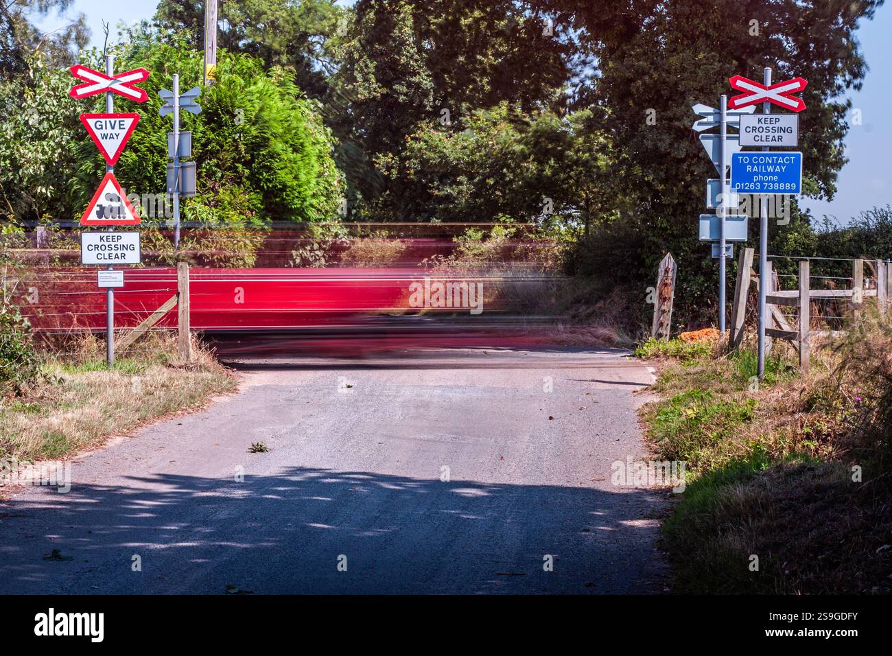 Steam loco blur on level crossing without barriers (prior to safety ...