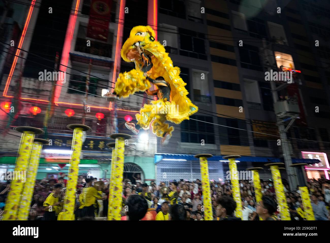Chinese artists leap from pedestals as they perform a traditional lion ...